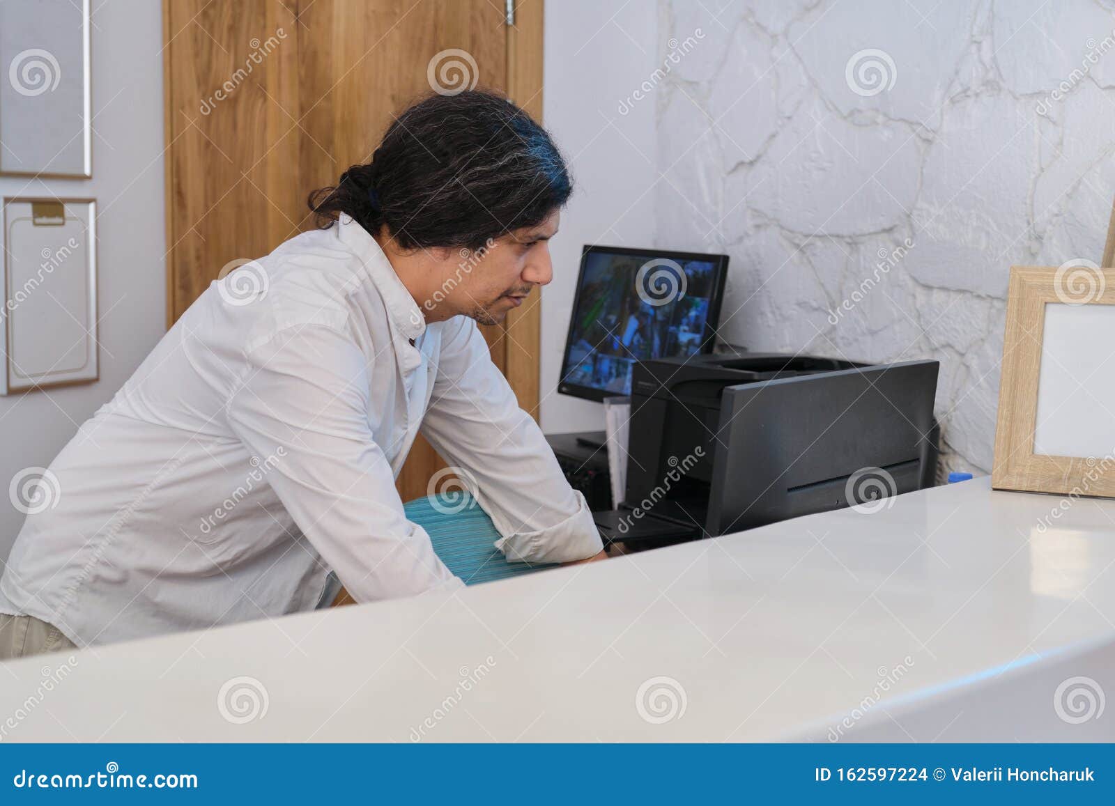 Portrait of Handsome Man Working at the Reception Desk in Resort Hotel ...
