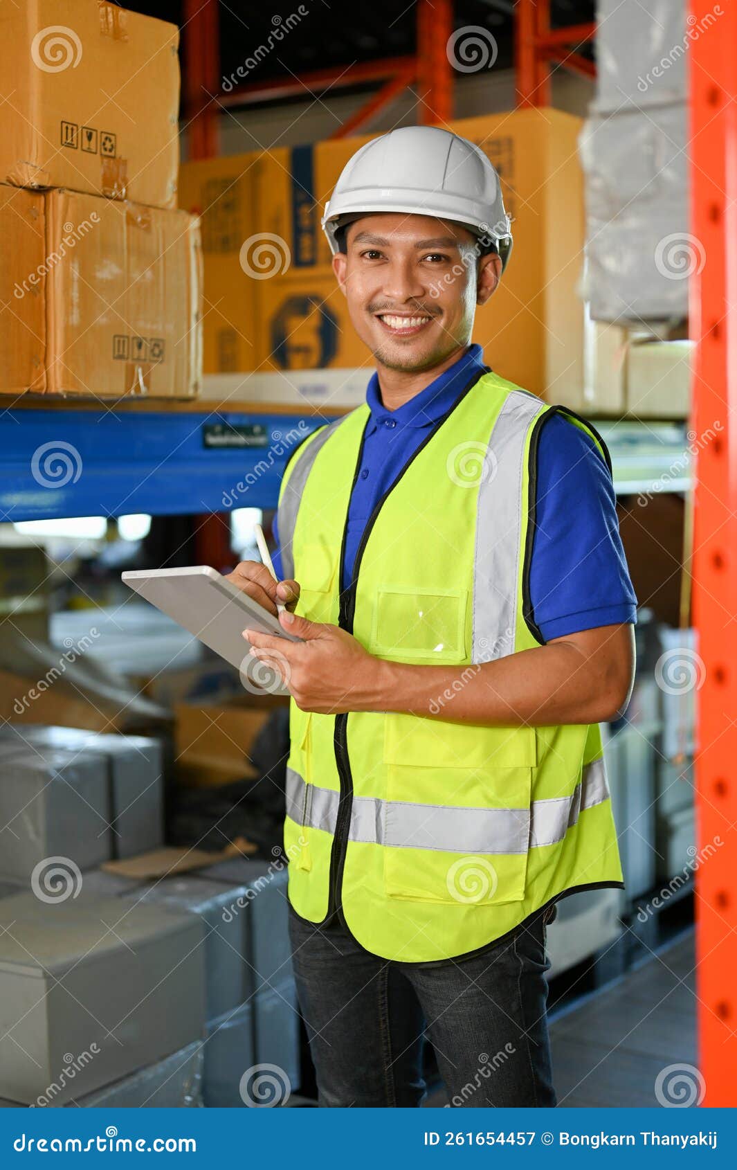 Handsome Asian Warehouse Worker Smiling, Looking at Camera while ...