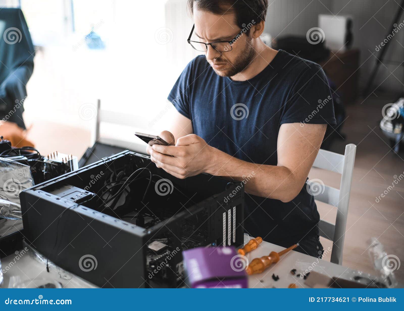 Handsome Nerd Man is Servicing Computer Motherboard and Cooler. Stock ...