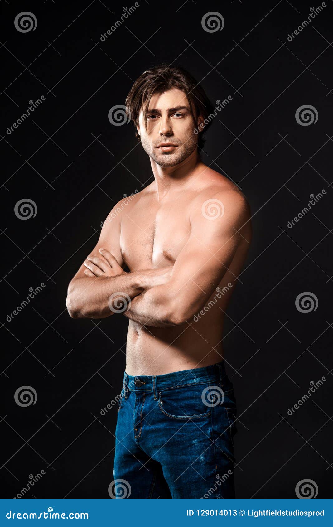 Portrait Of Handsome Shirtless Man With Arms Crossed Looking At Camera