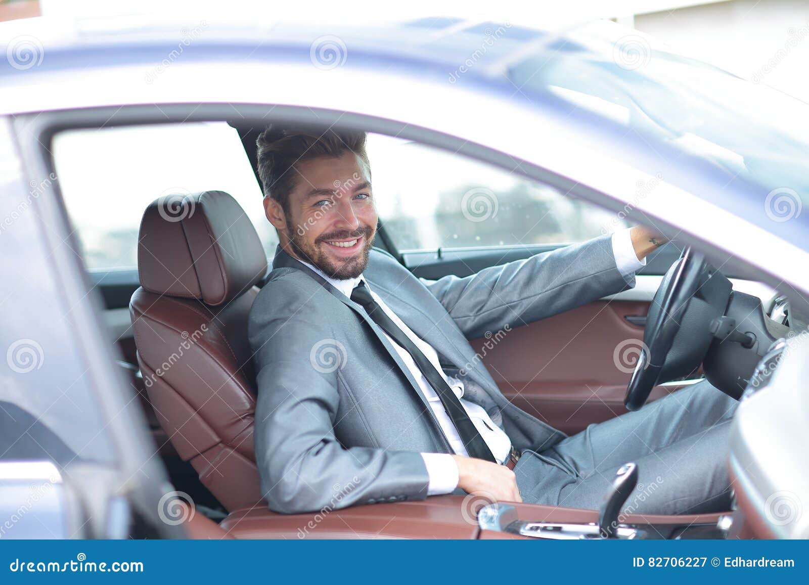Portrait Of An Handsome Smiling Business Man Driving His Car Stock