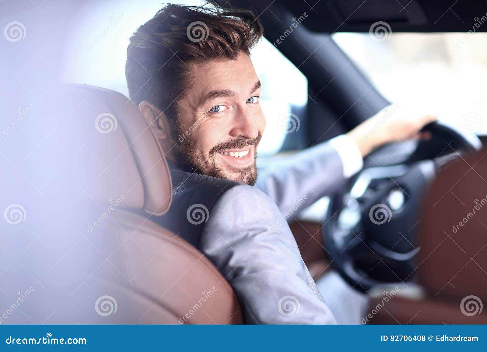 Portrait Of An Handsome Smiling Business Man Driving His Car Stock