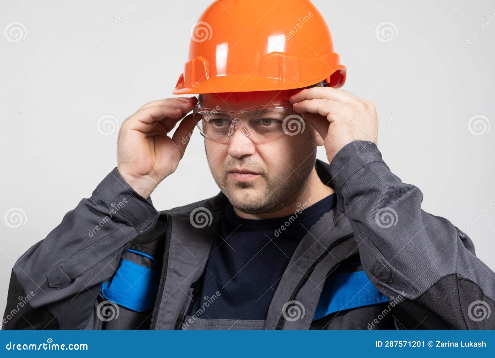 Portrait of a Handsome Worker Builder in Overalls, Helmet and Glasses ...