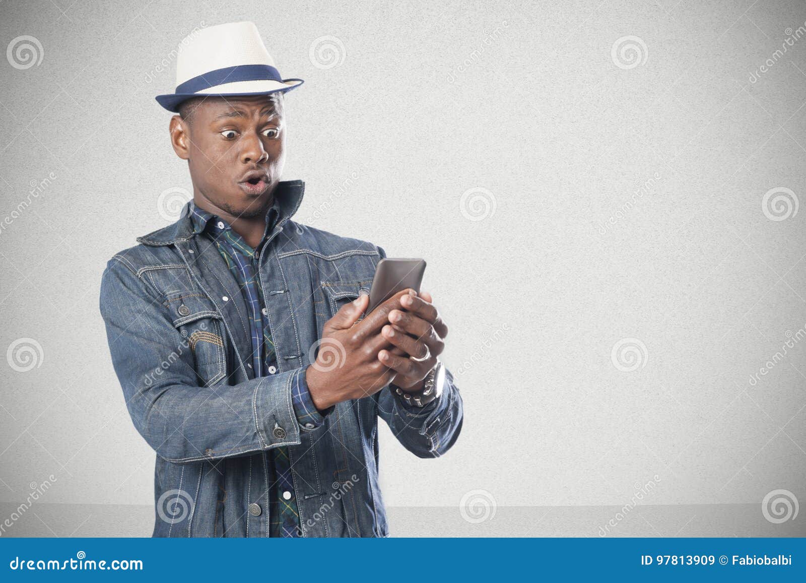 Portrait of a Handsome Young African Man Standing with a Mobile Stock ...