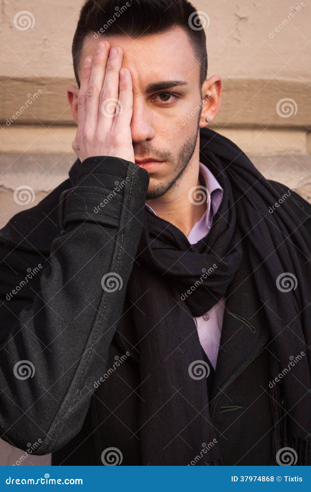 Portrait of a Handsome Young Man Keeping a Hand on His Face Stock Photo ...