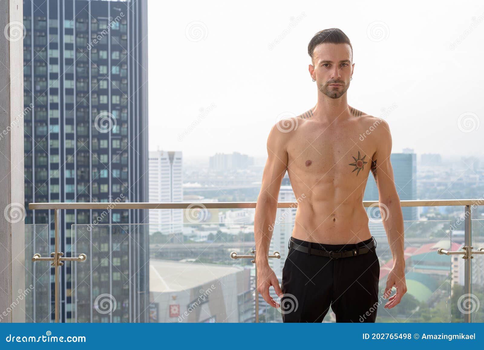 Portrait of Handsome Young Man Shirtless Outdoors at Rooftop in City ... Portrait of Handsome Young Man Shirtless Outdoors at Rooftop in City ...