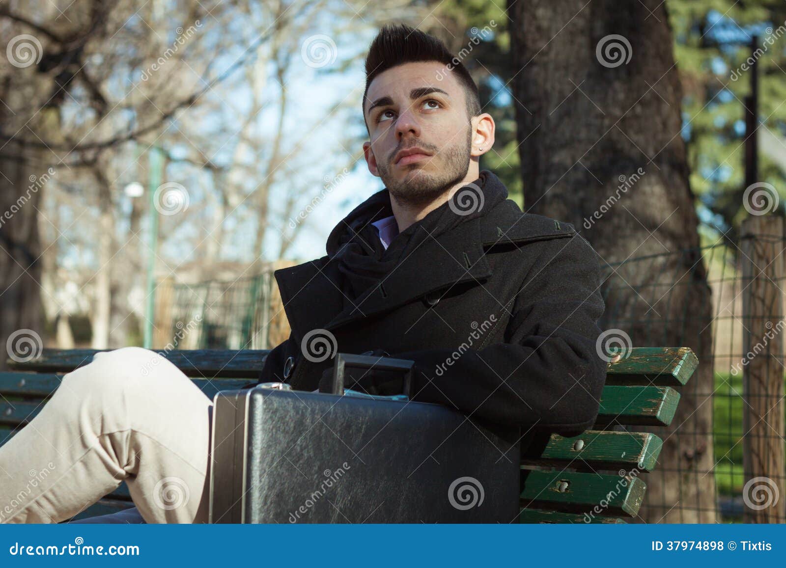 Portrait of a Handsome Young Man Sitting on a Bench Stock Photo - Image ...