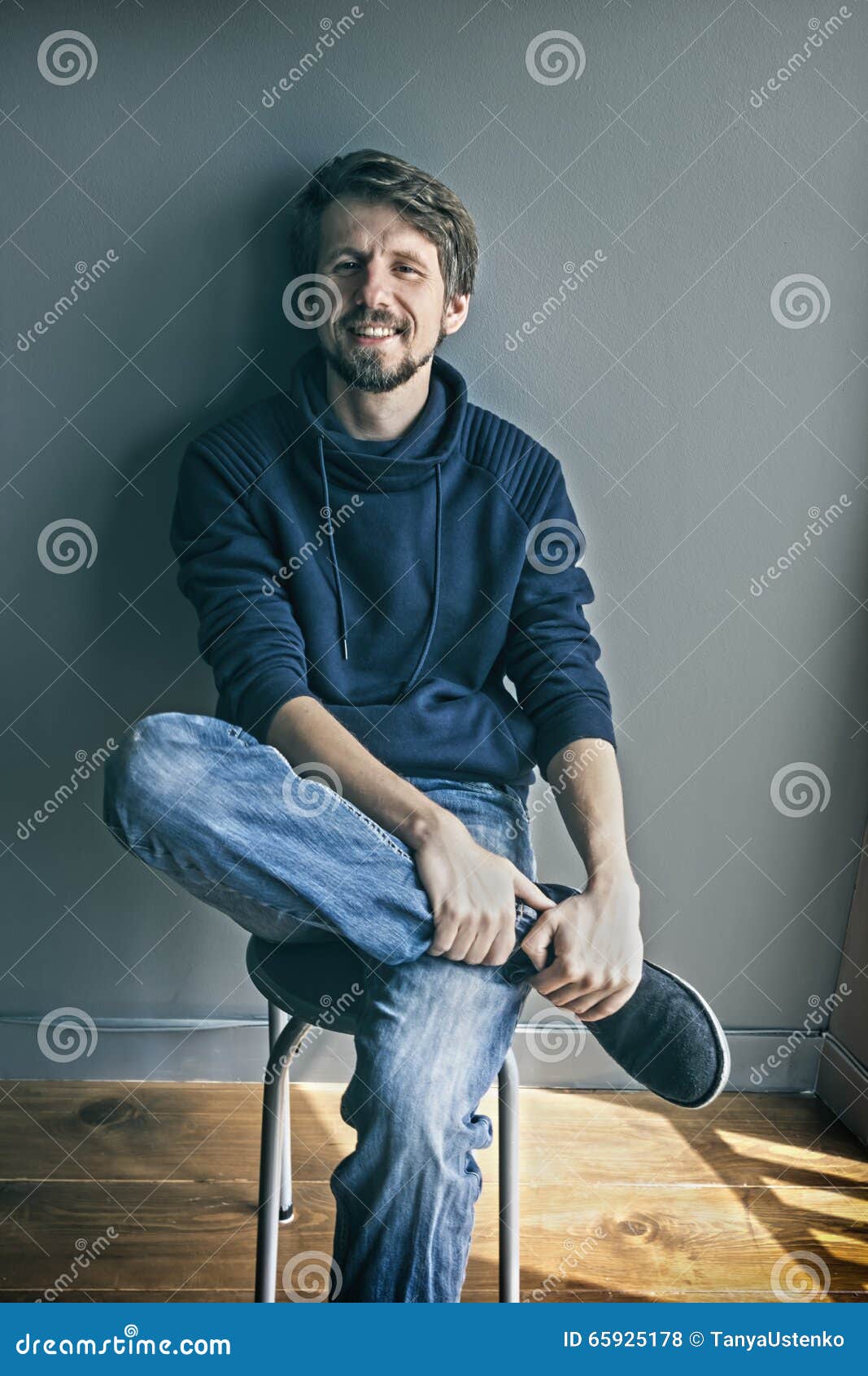Portrait of a Handsome Young Man Smiling Against Blue Gray Backg Stock ...