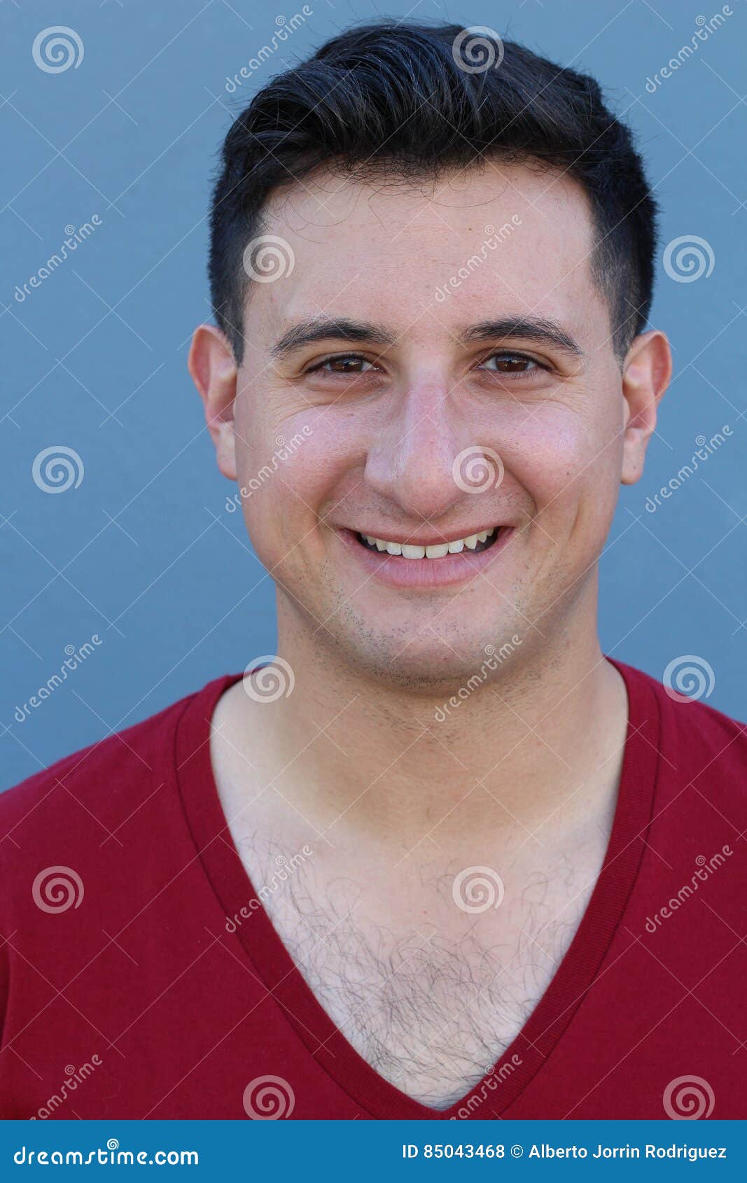 Portrait of a Handsome Young Man Smiling at Camera, on Blue Stock Photo ...