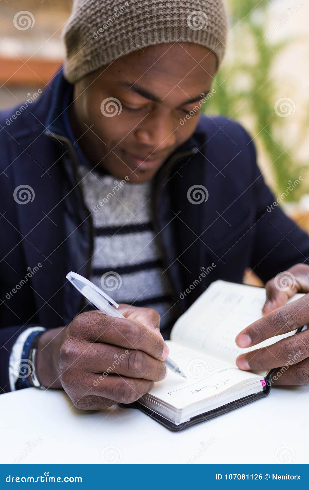 Handsome Young Man Writing in a Notebook. Stock Photo - Image of ...