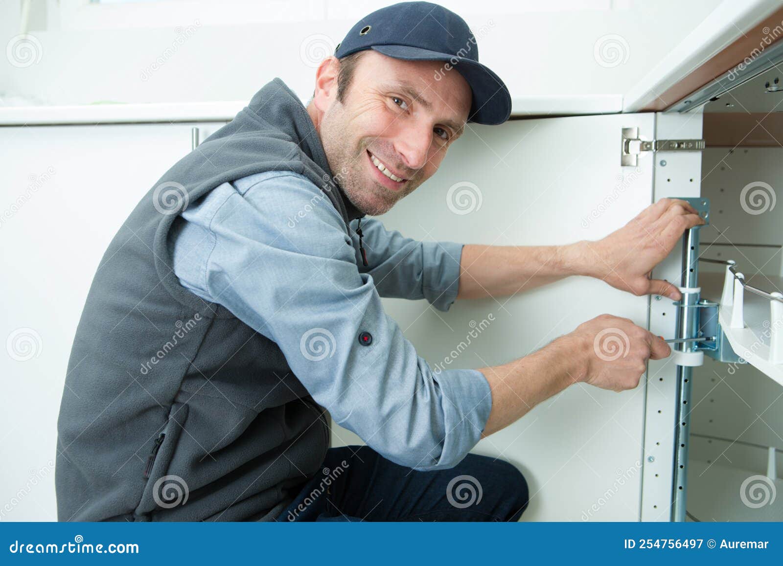 Portrait Handyman Installing Kitchen Cupboard Stock Image - Image of ...