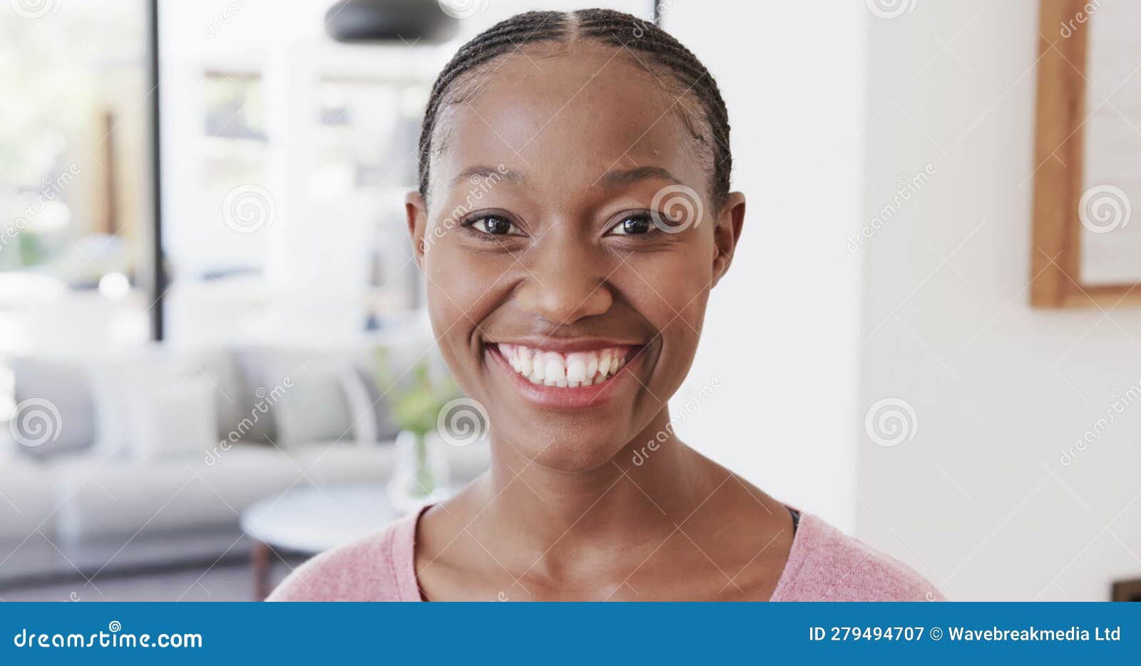 Portrait Of Happy African American Woman Smiling In Living Room At Home