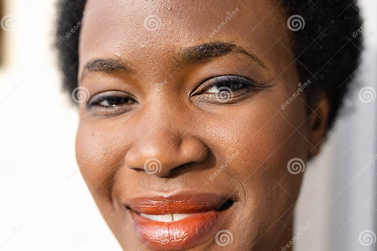 Portrait Of Happy African American Woman Staying Against White Wall
