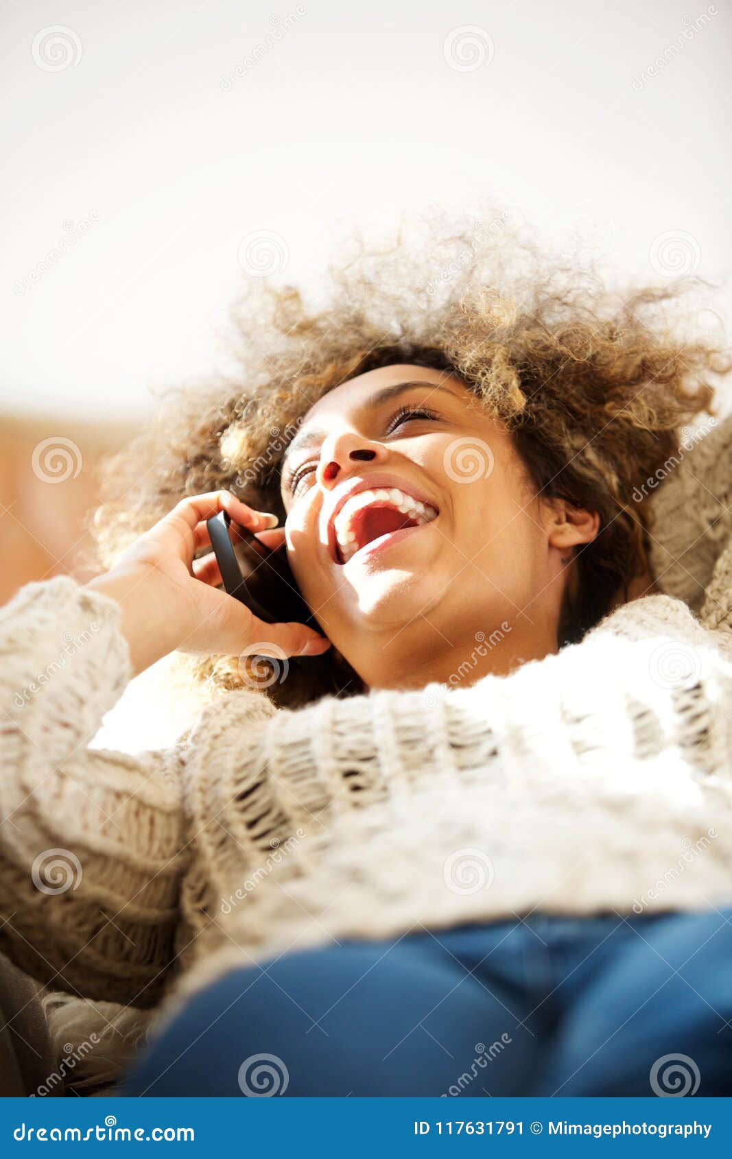 Happy African American Woman Talking On Cellphone And Laughing Stock