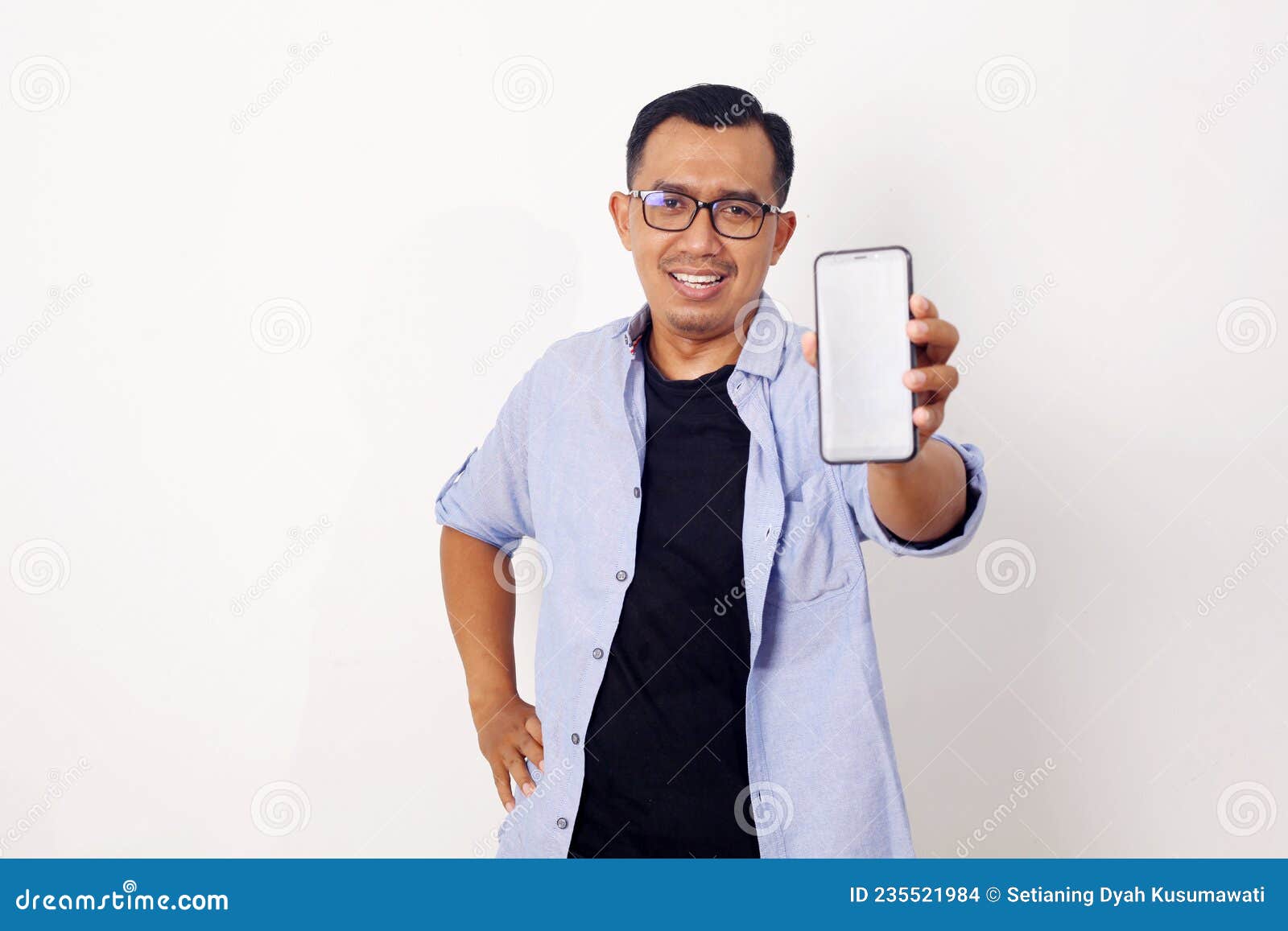 Portrait Of Happy Asian Man While Standing And Holding A Phone Cellular