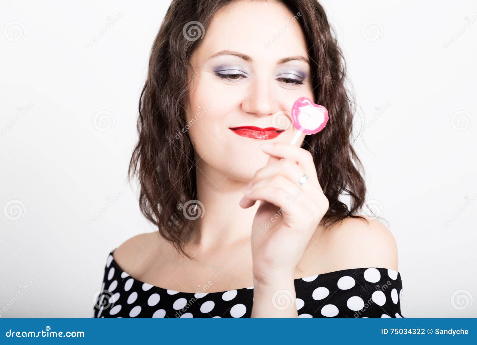 Portrait Of Happy Beautiful Young Woman Licking Sweet Candy And