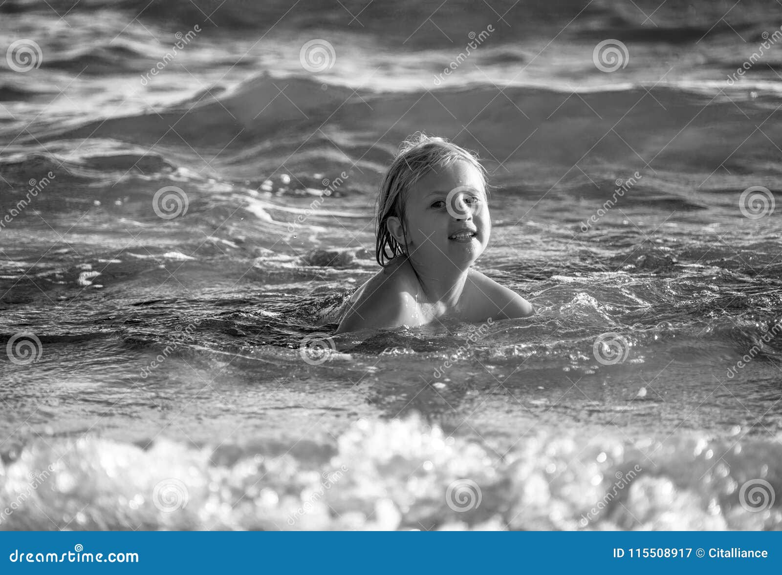 Blond child bathing in sea stock image. Image of splashing - 115508917