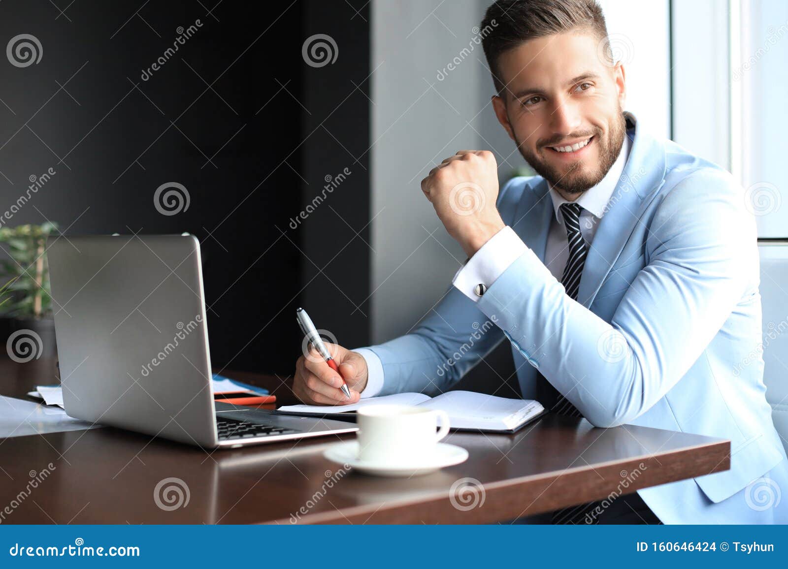 Portrait of Happy Businessman Sitting at Office Desk, Looking at Camera ... Portrait of Happy Businessman Sitting at Office Desk, Looking at Camera ...