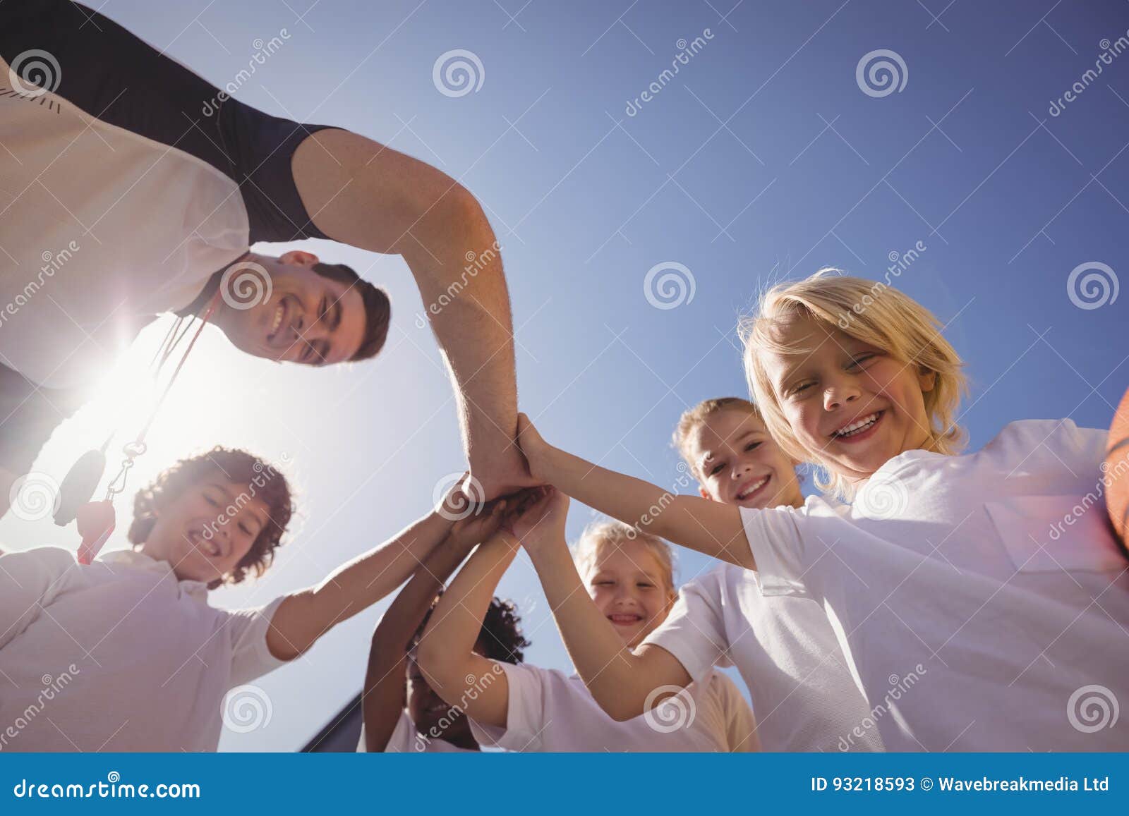 Portrait of Happy Coach and Schoolkids Forming Handstack Stock Image ...