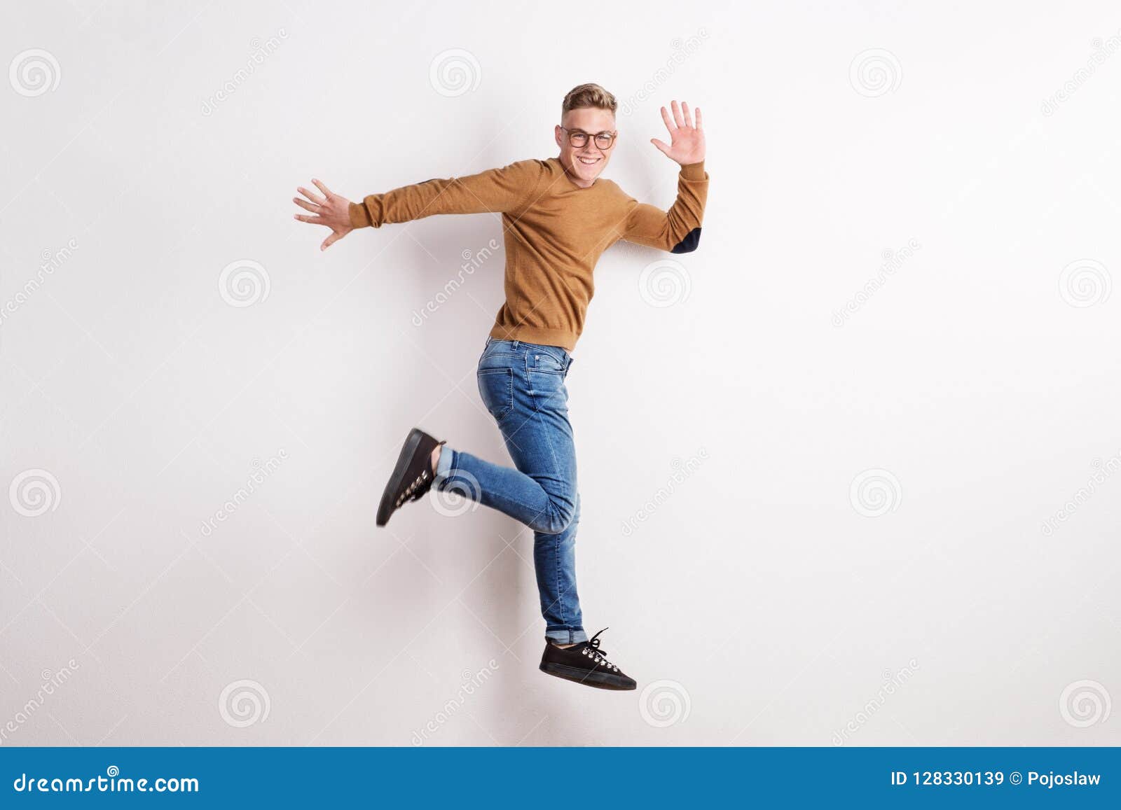 Portrait of a Happy Young Man in a Studio, Jumping. Stock Image - Image ...