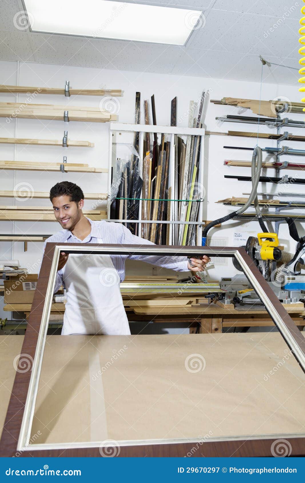 Portrait of a Happy Craftsman Working on Picture Frame in Workshop ...