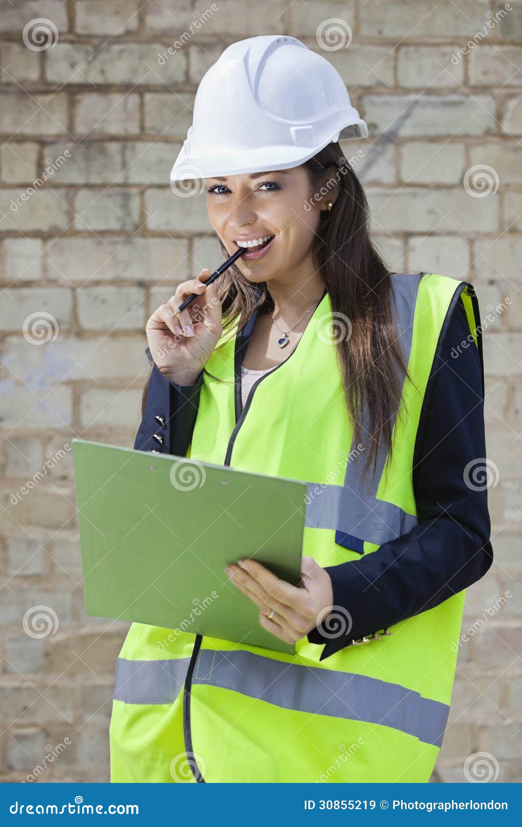 Portrait of a Happy Female Supervisor with Clipboard Standing at ...