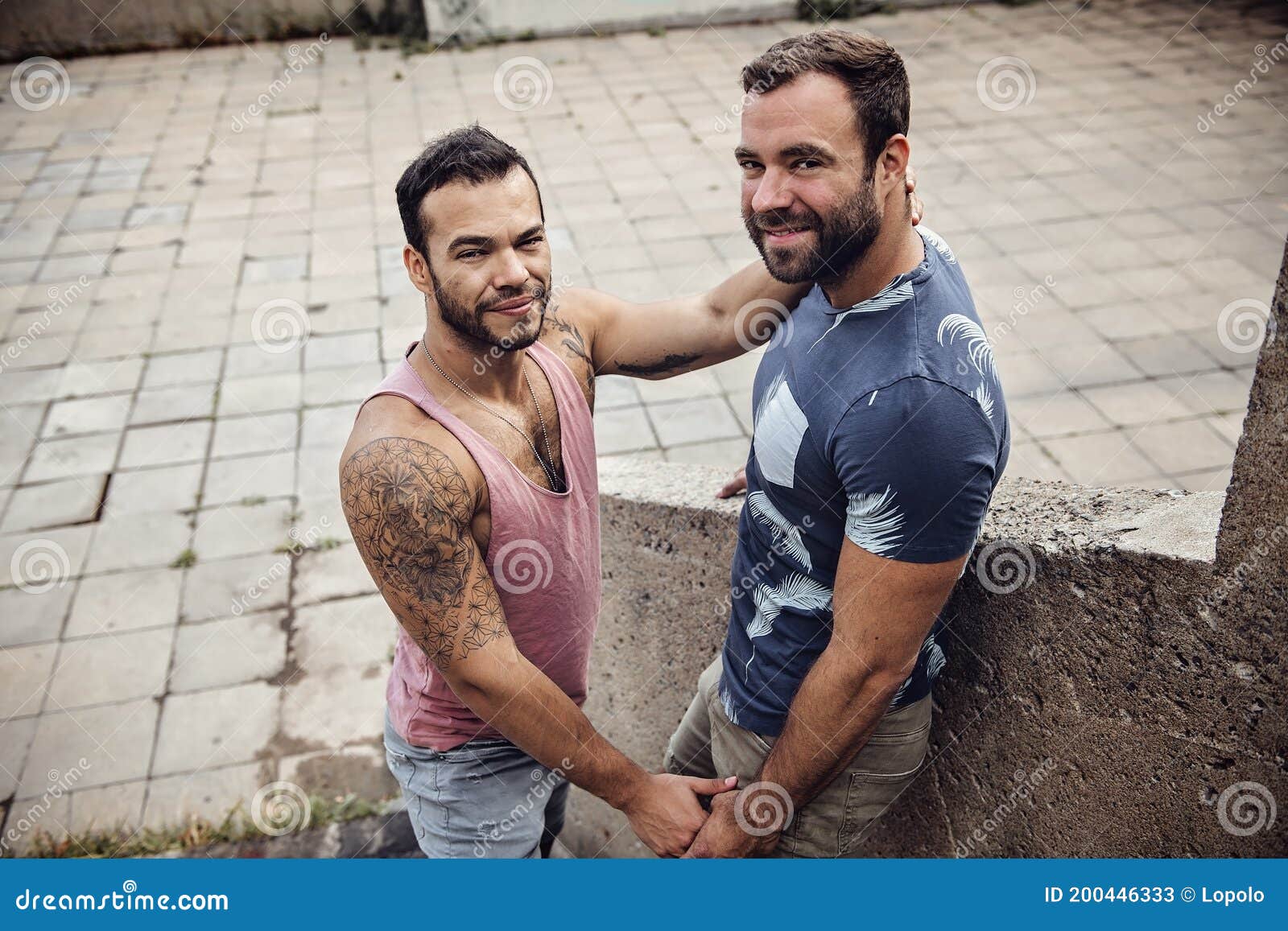 A Portrait Of A Happy Gay Couple Outdoors In Urban Background Stock