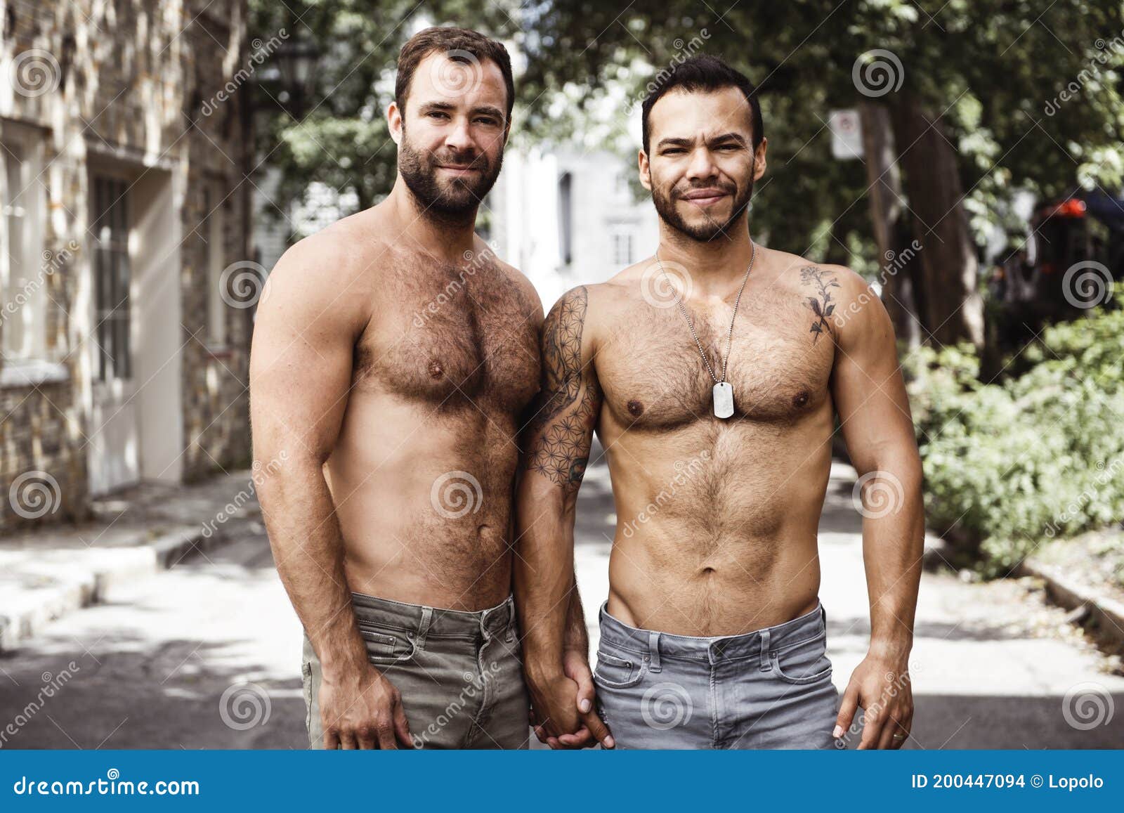 A Portrait Of A Happy Gay Couple Outdoors In Urban Background Stock