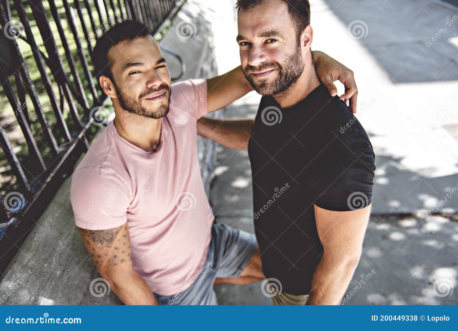 A Portrait Of A Happy Gay Couple Outdoors In Urban Background Stock