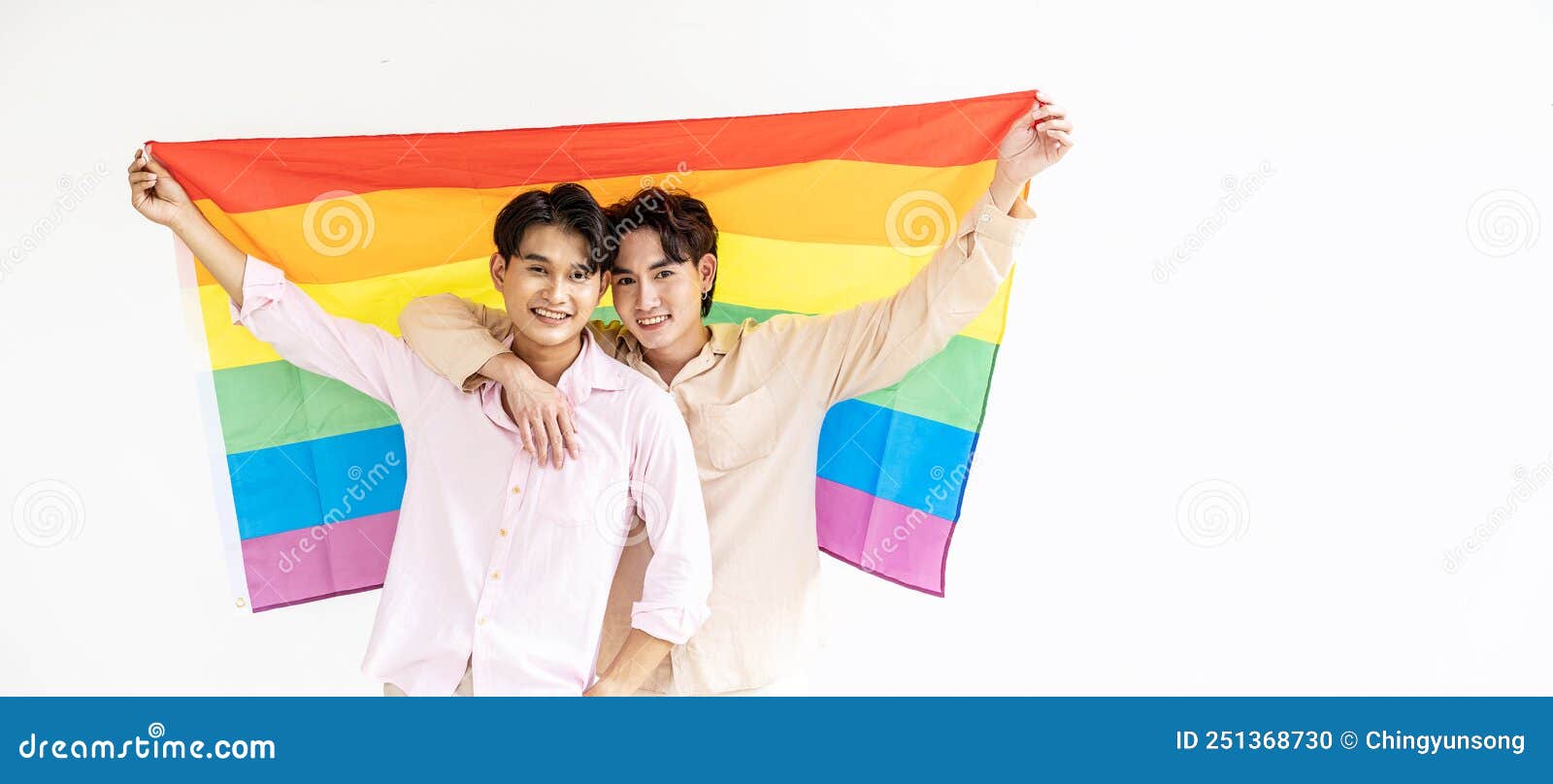 Portrait Of Happy Gay Couple Showing Their Love With Rainbow Flag