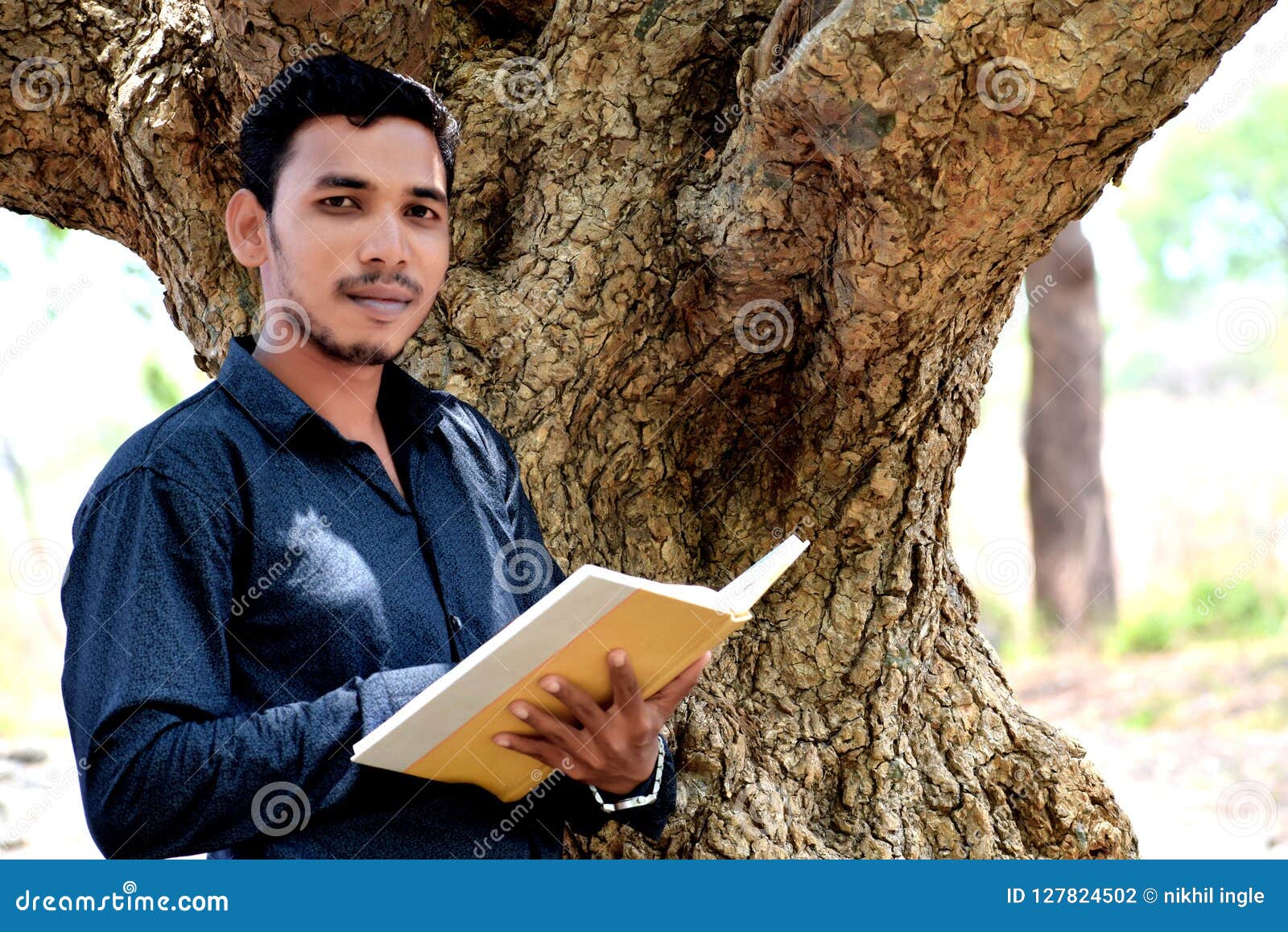 Portrait of Happy Young Man Reading Book Outdoor Stock Photo - Image of ... Portrait of Happy Young Man Reading Book Outdoor Stock Photo - Image of ...