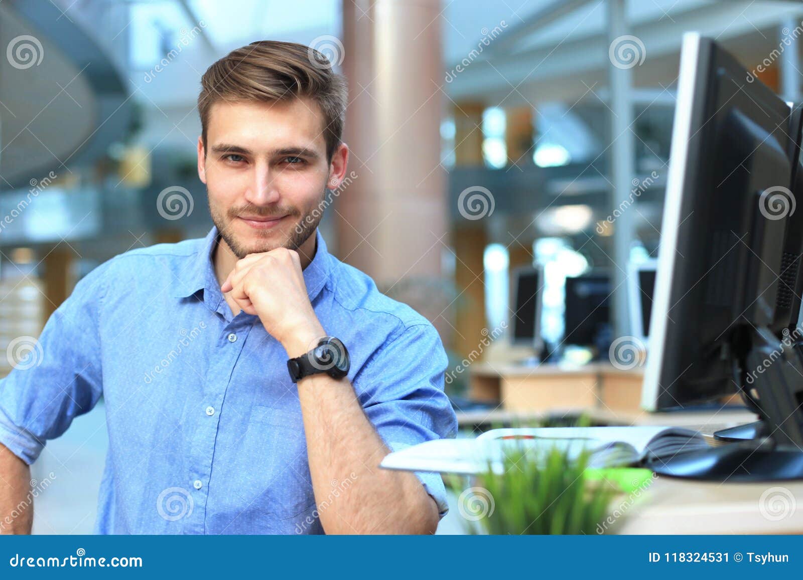 Portrait of Happy Man Sitting at Office Desk, Looking at Camera ...