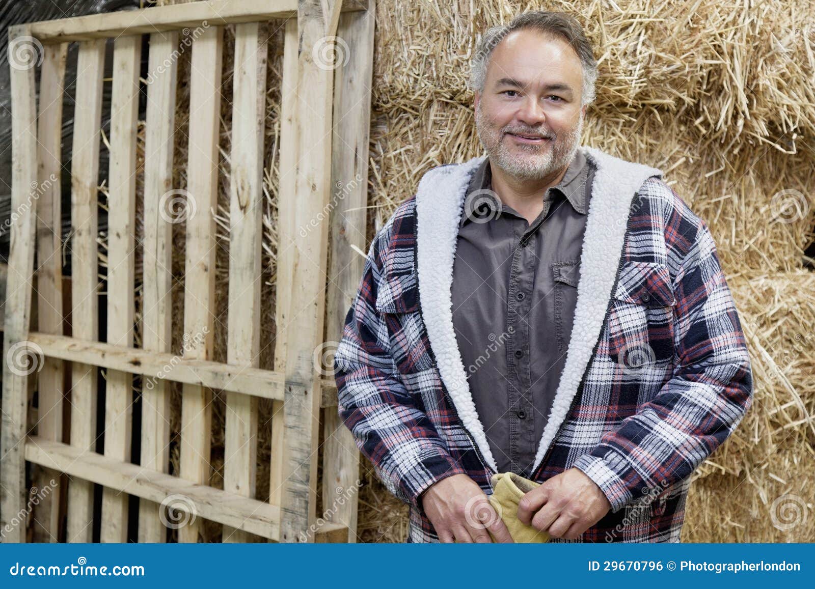 Portrait of Happy Mature Male Standing in Front of Hay Stack Stock ...