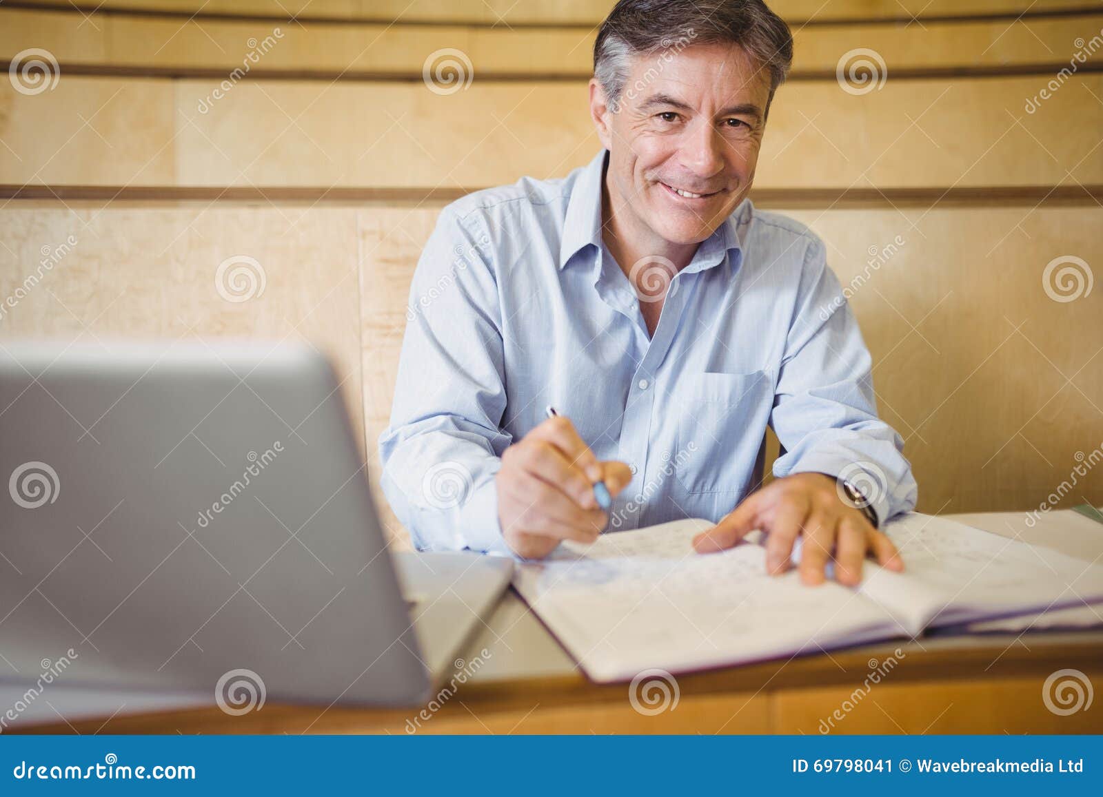 Portrait of Happy Professor Writing in Book at Desk Stock Image - Image ...