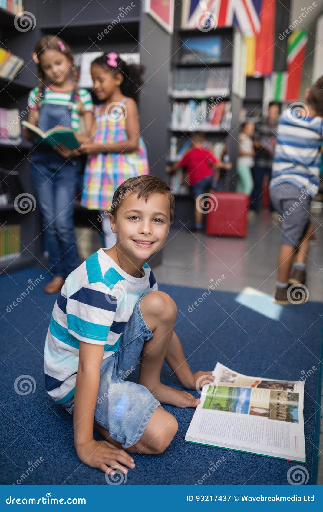 Portrait of Happy Schoolboy Reading Book in Library Stock Image - Image ...