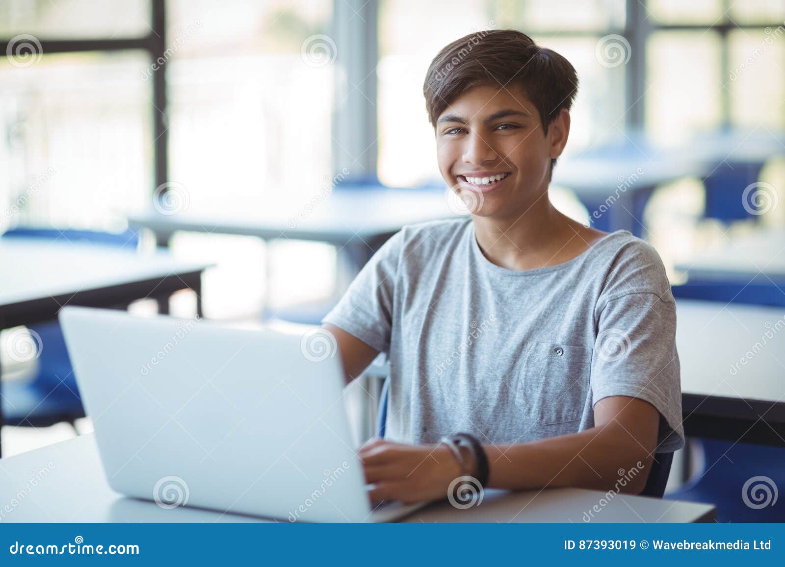 Portrait of Happy Schoolboy Using Laptop in Classroom Stock Image ...