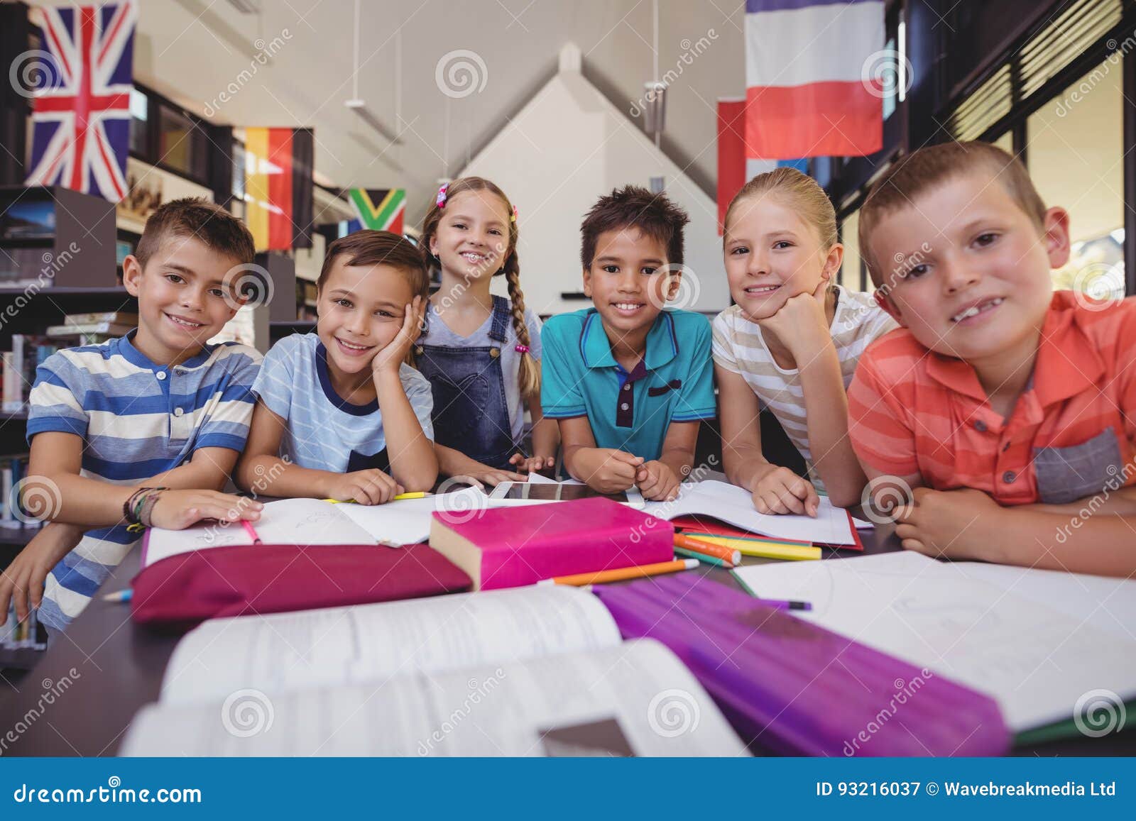Portrait of Happy Schoolkids Studying at Table in Library Stock Image ...