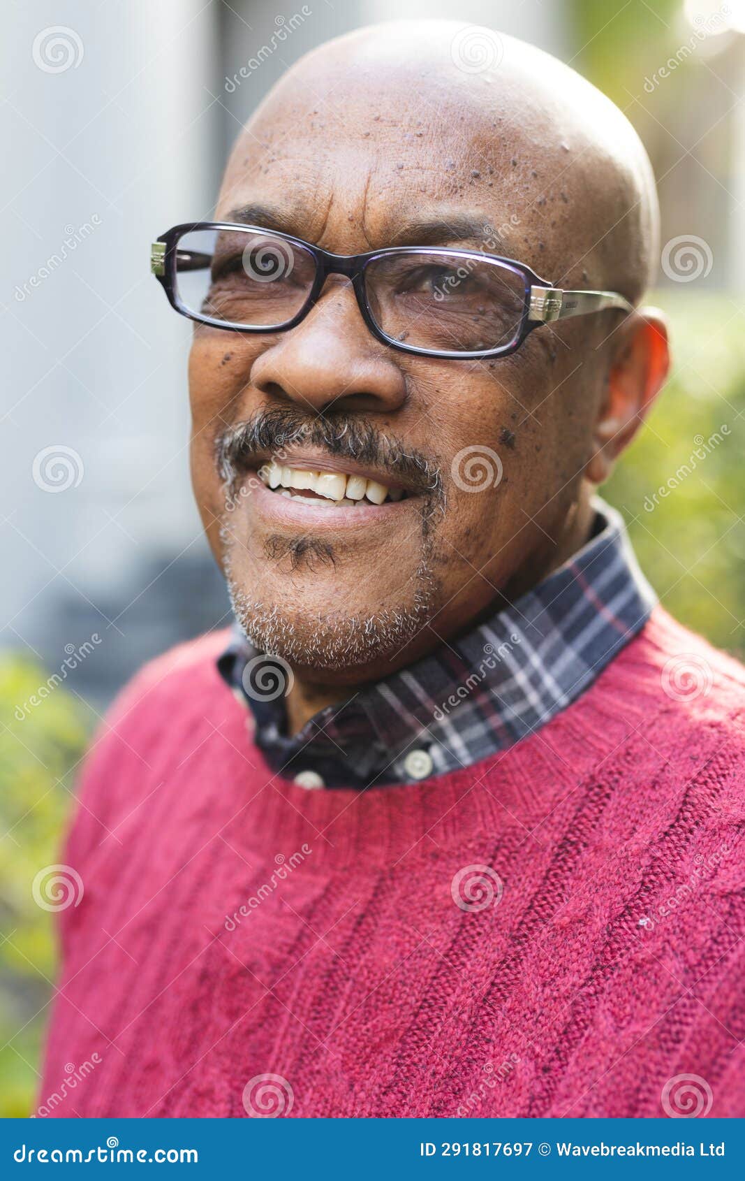 Portrait Of Happy Senior African American Man Wearing Glasses And Red