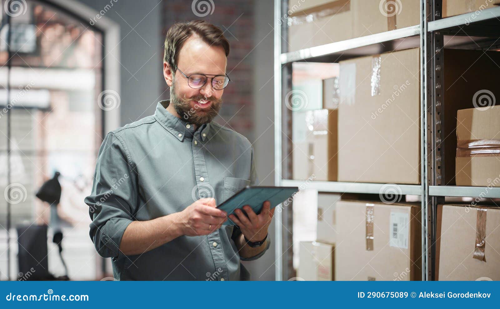 Portrait of a Happy Small Warehouse Employee Checking Inventory, Using ...