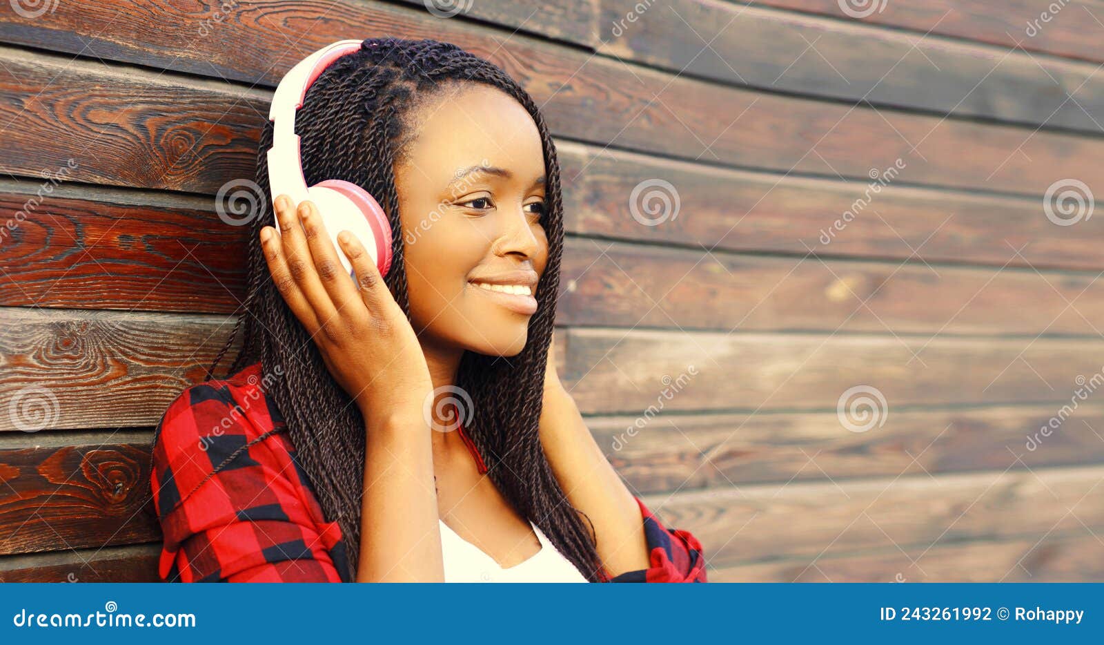 Portrait Of Happy Smiling African Woman Listening To Music In