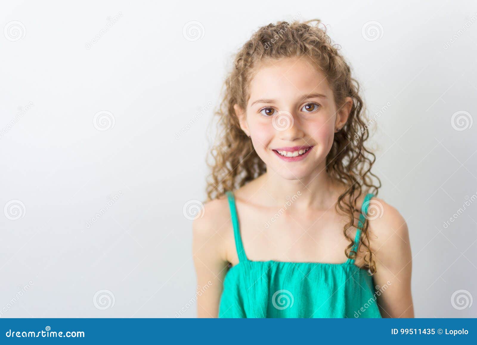 Portrait Of Happy Smiling Confident 9 Years Old Girl With Curly Hair