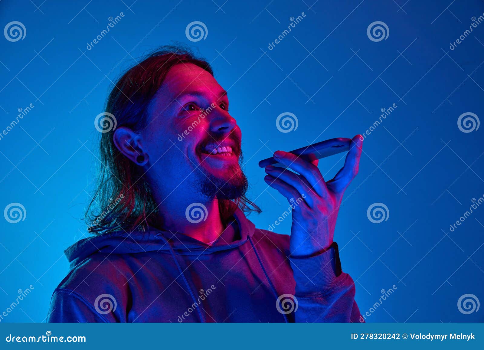 Portrait Of Happy Smiling Man Cheerfully Talking On Mobile Phone