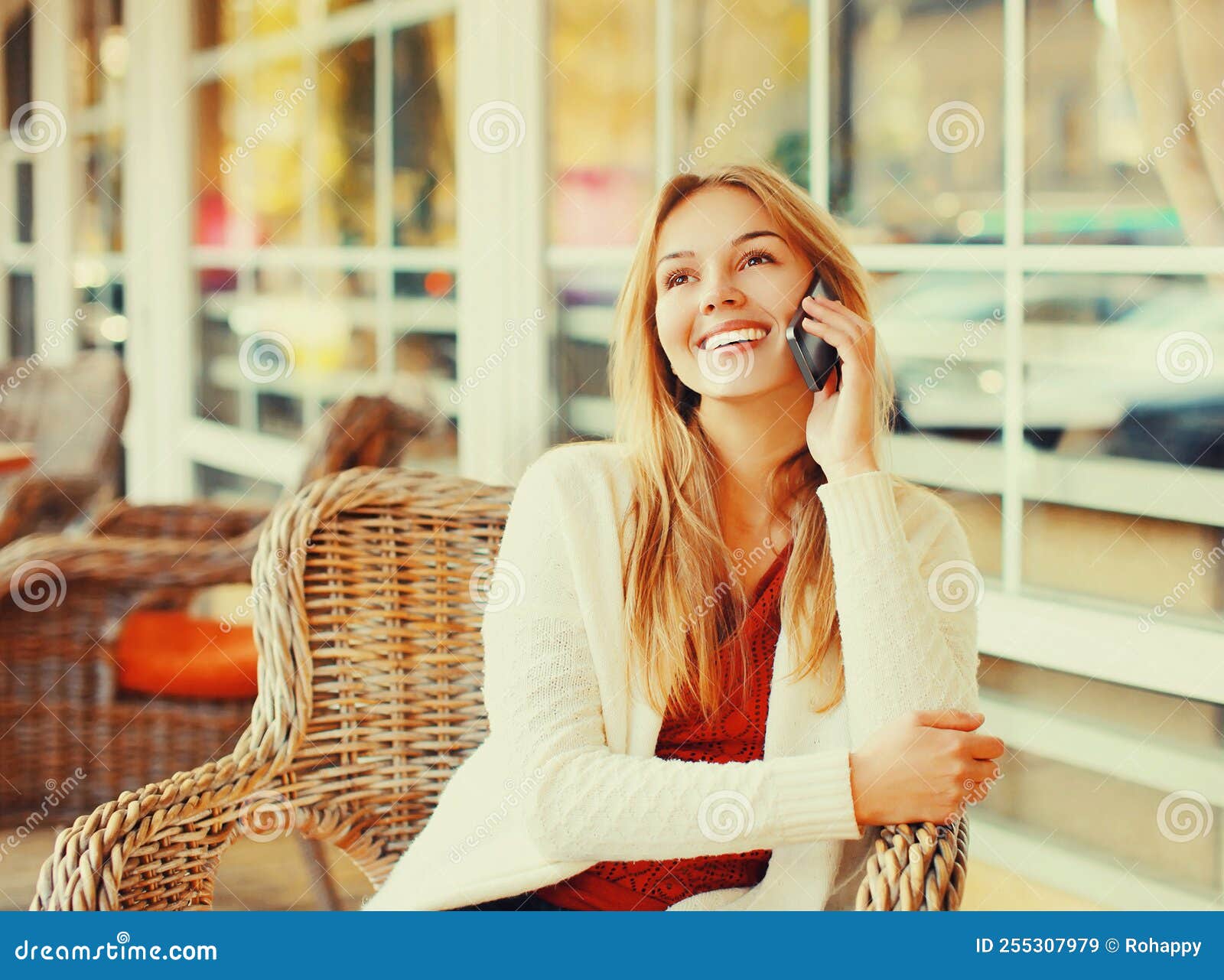 Portrait Of Happy Smiling Woman Calling On Smartphone Sitting At The