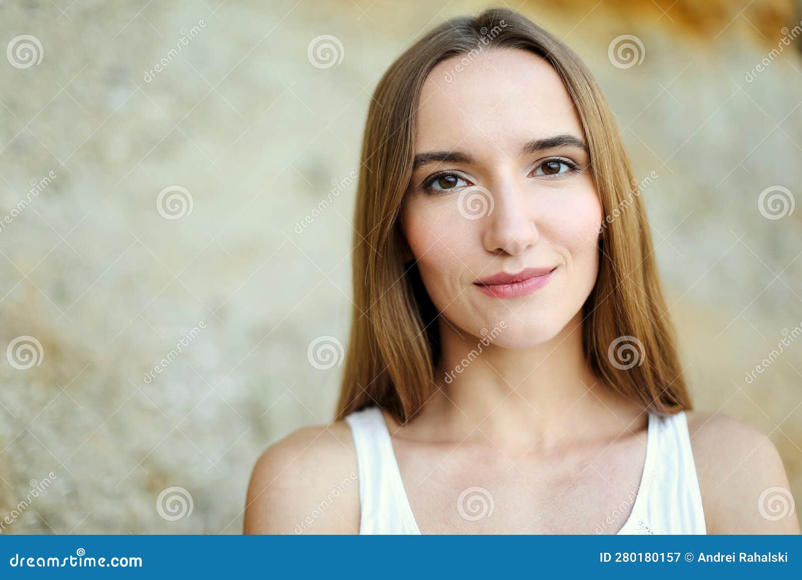 Portrait Of A Happy Smiling Woman Standing And Looking At The Camera In