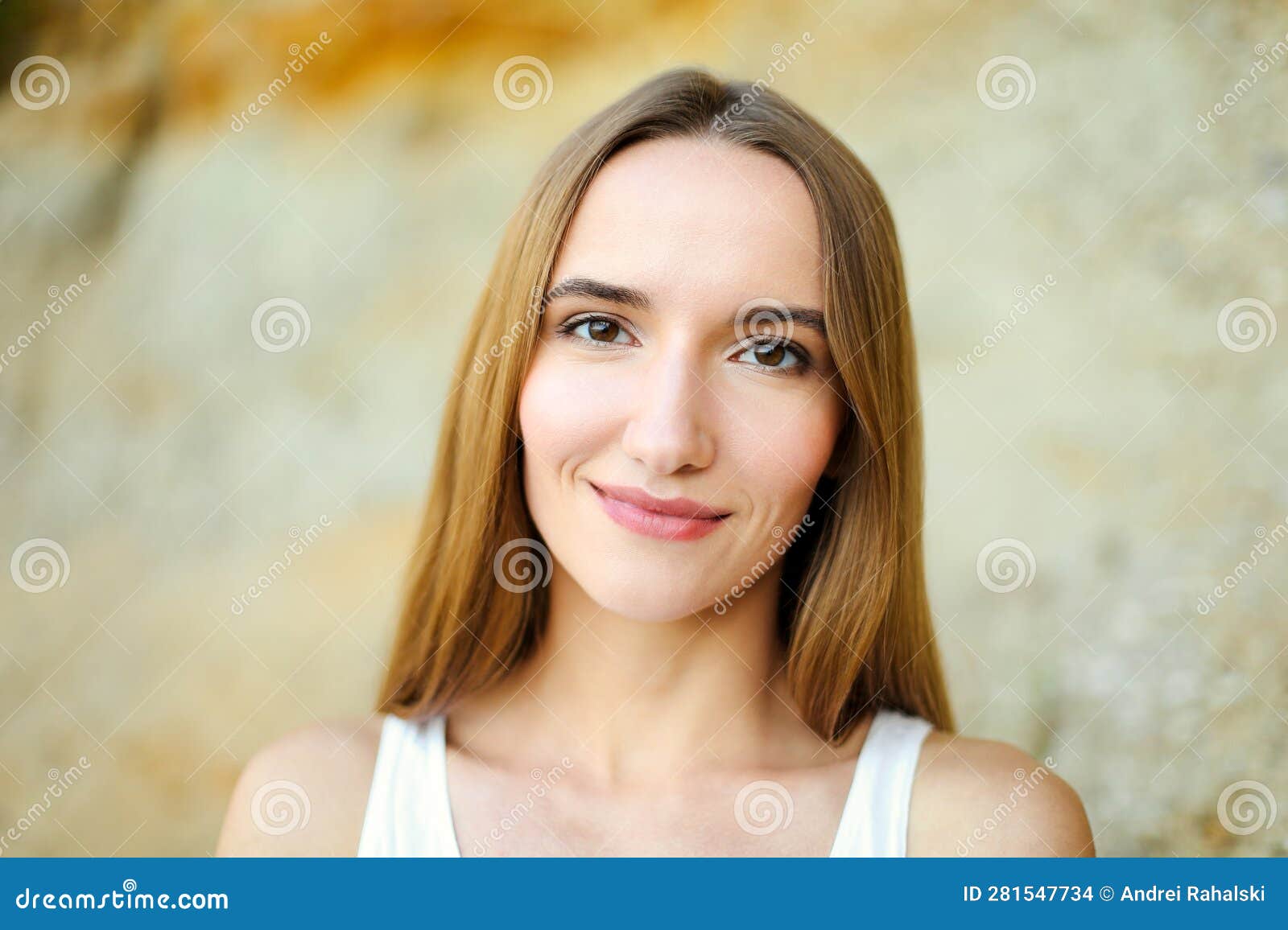 Portrait Of A Happy Smiling Woman Standing And Looking At The Camera In