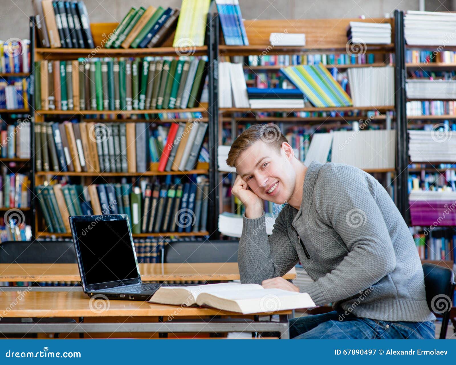 Portrait of a Happy Student with Laptop in the University Library Stock ...