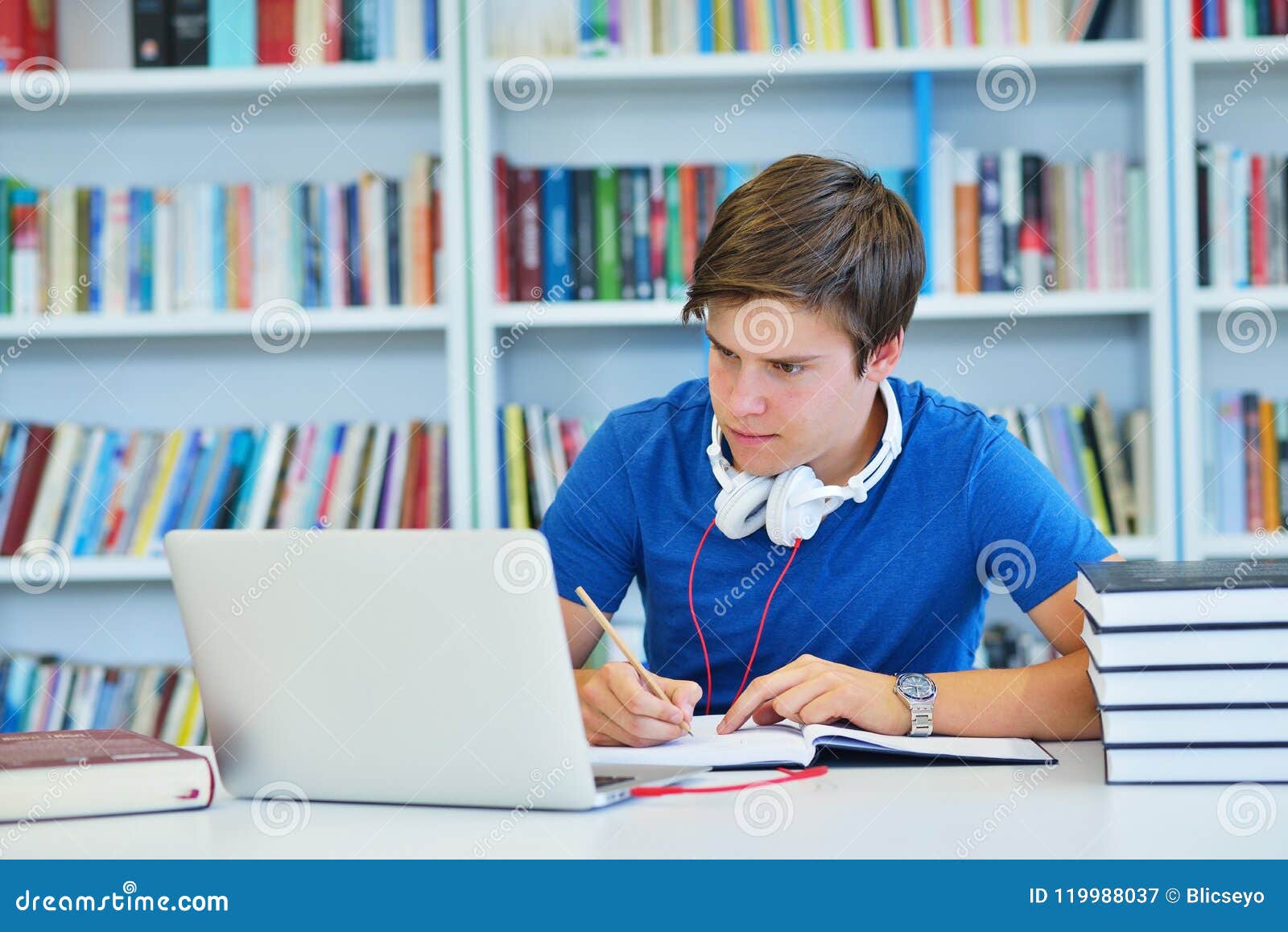 Portrait of Happy Student while Reading Book in School Library. Stock ...