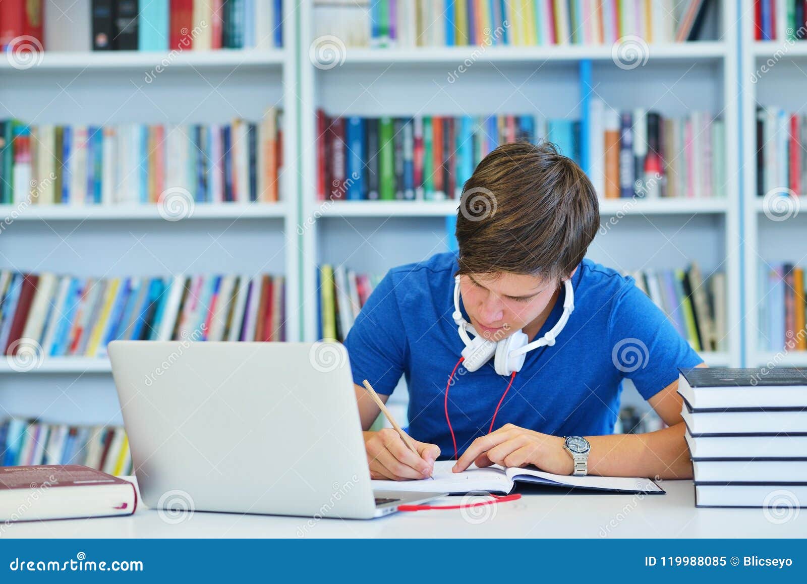 Portrait of Happy Student while Reading Book in School Library. Stock ...