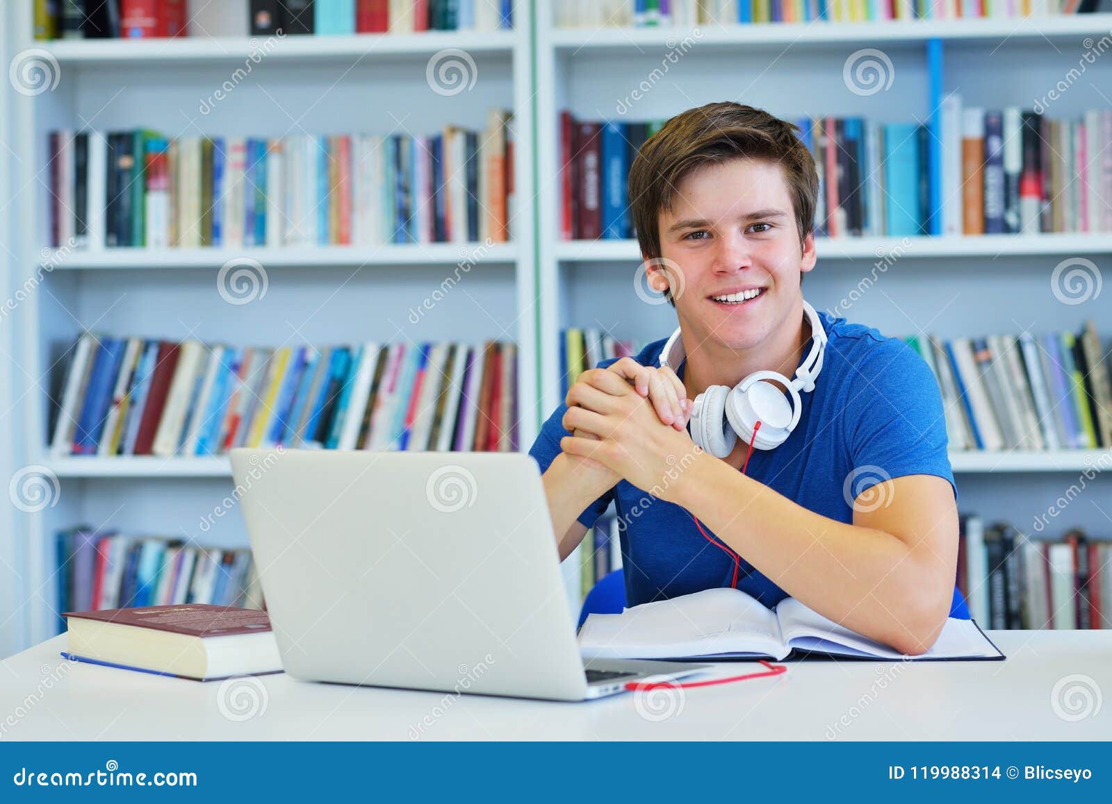Portrait of Happy Student while Reading Book in School Library. Stock ...