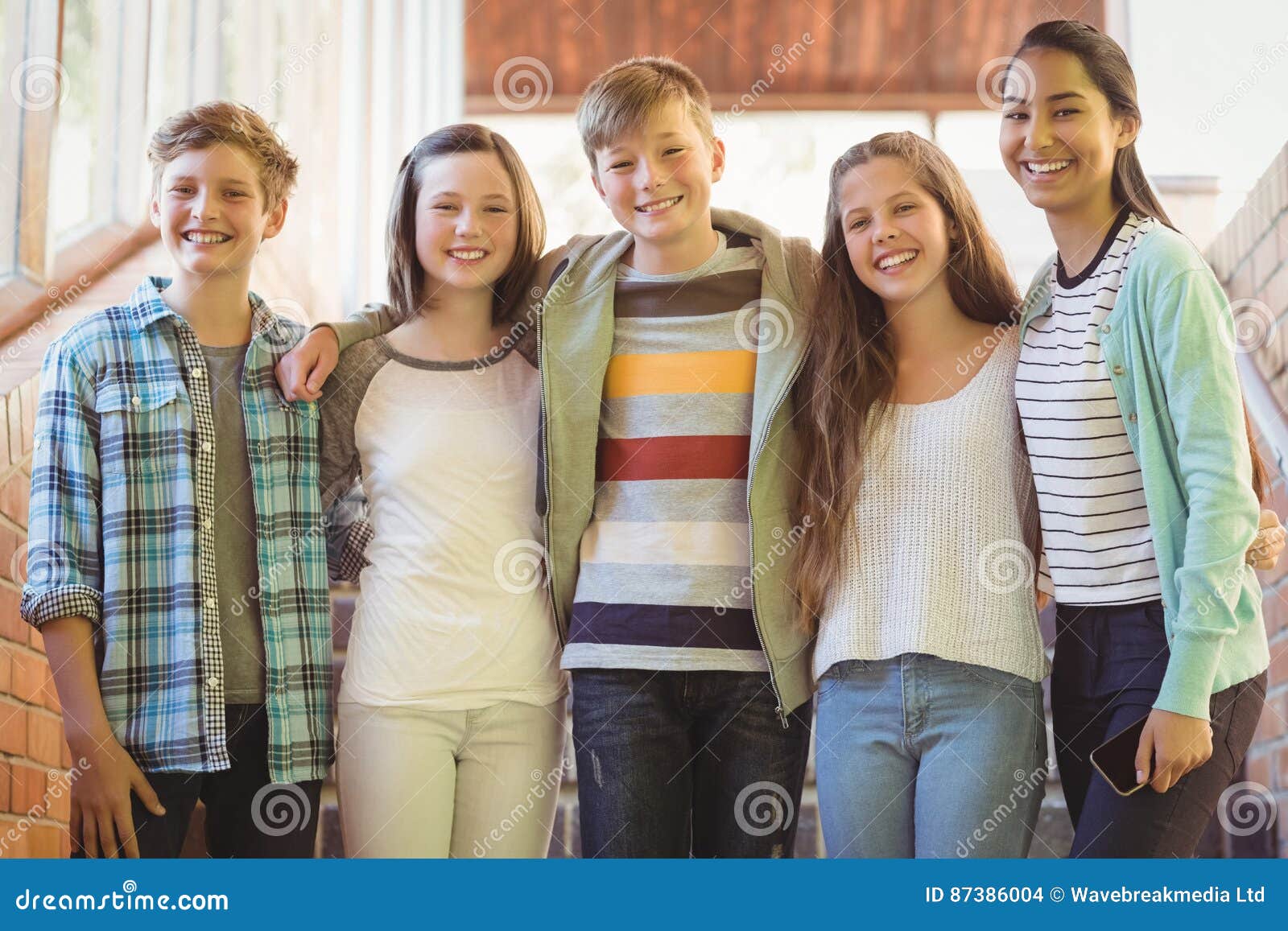 Portrait of Happy Students Standing with Arms Around in Corridor Stock ...